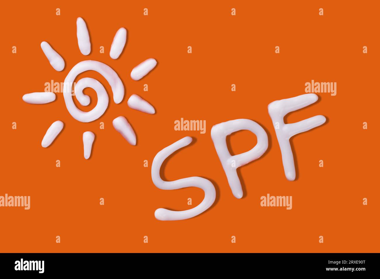 SPF cream. Sunscreen cream in a sun shape on orange background ...