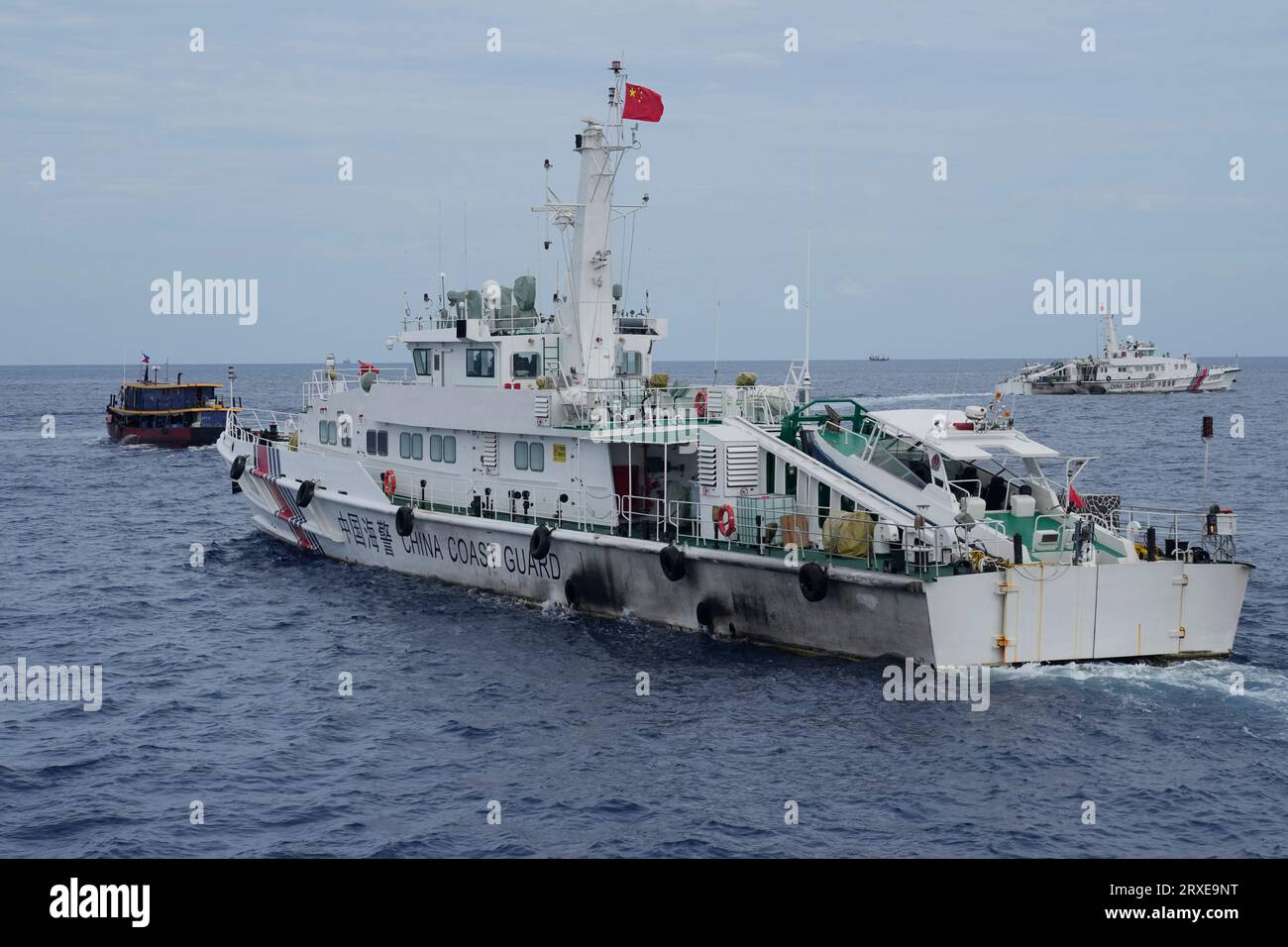 FILE - A Chinese coast guard ship tries to block the way of a ...