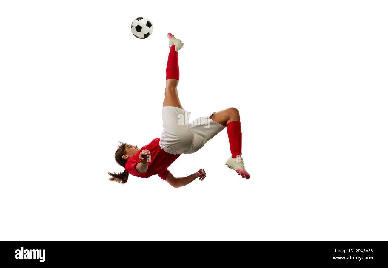 Competitive young girl, football player in motion, kicking ball and ...