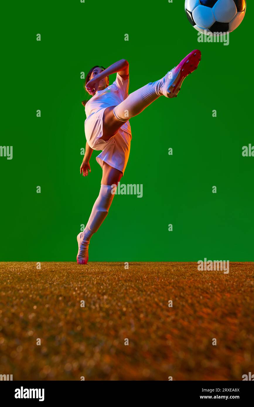Bottom view, dynamic image of young woman, football player in motion ...