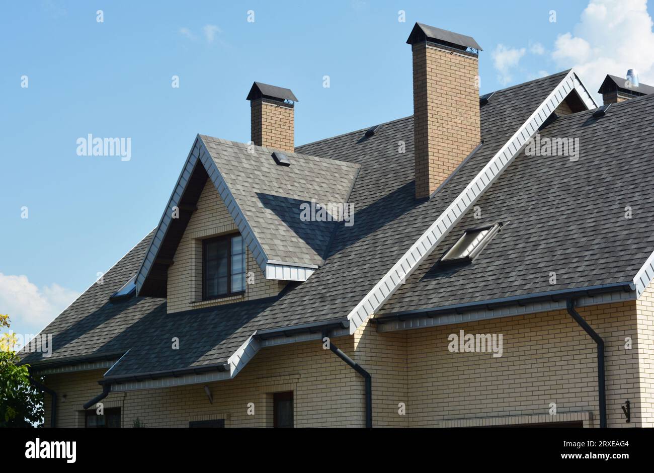 House asphalt shingles rooftop with dormer window, attic skylights ...