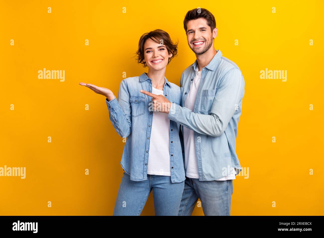 Photo of positive two promoters lady guy hold hand pointing advert ...