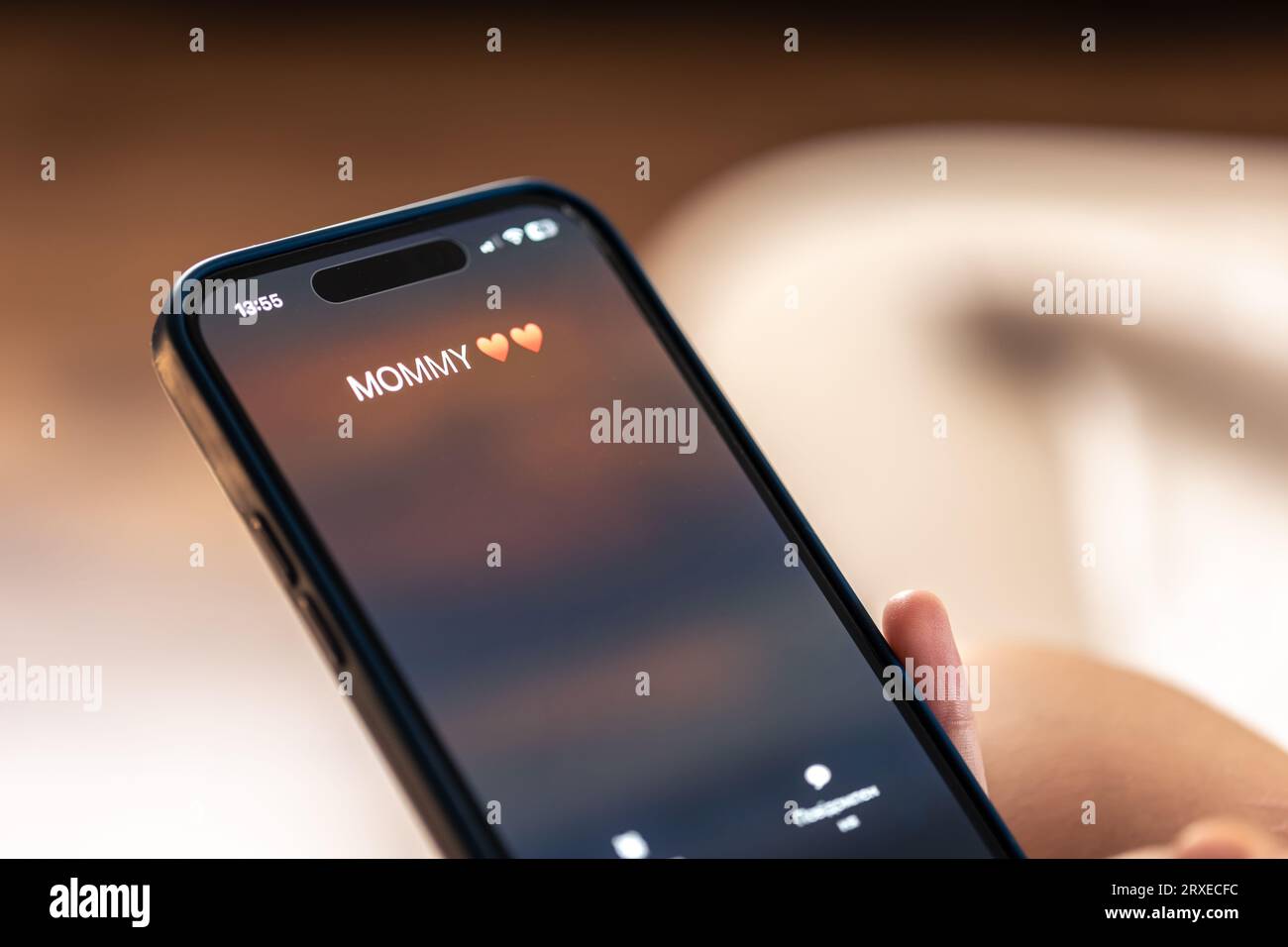 Smartphone in child hands with Incoming Mommy call on a screen Stock ...