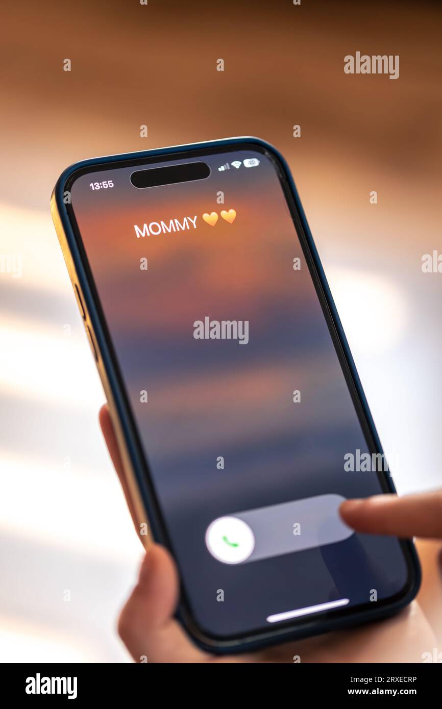 Smartphone in child hands with Incoming Mommy call on a screen Stock ...