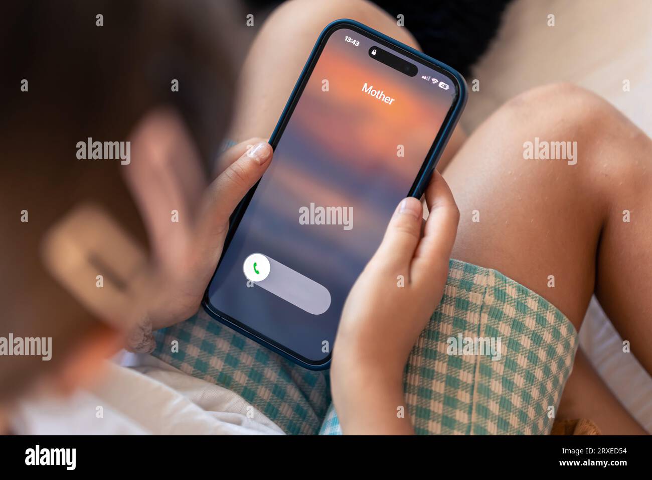 Smartphone in child hands with Incoming mother call on a screen Stock ...