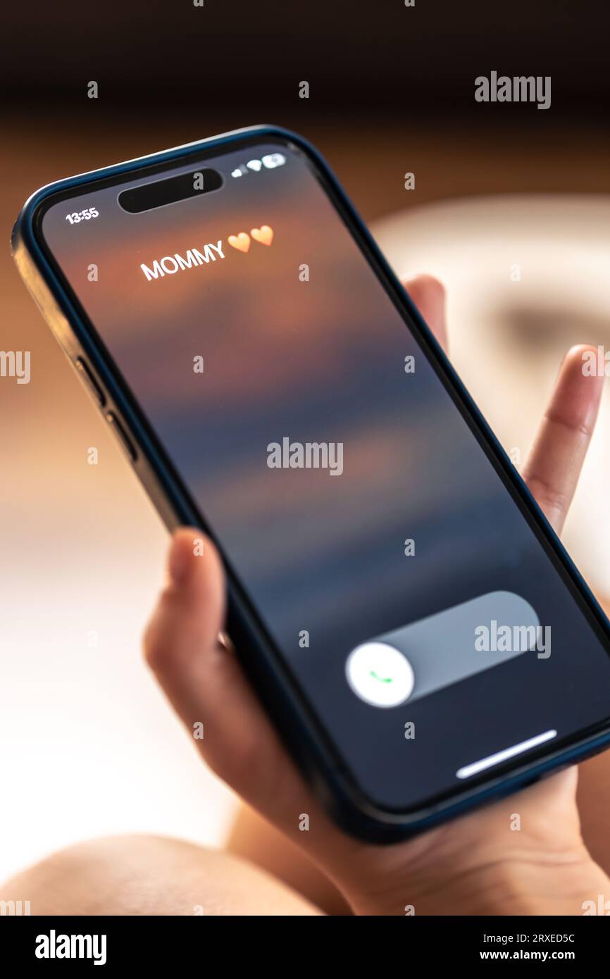 Smartphone in child hands with Incoming Mommy call on a screen Stock ...