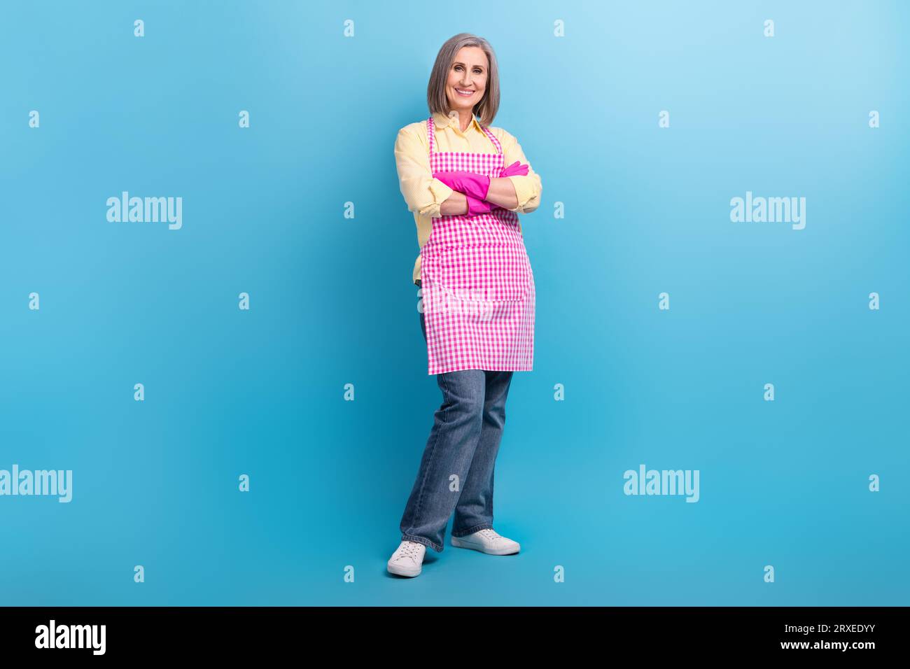 Full size portrait of positive satisfied aged lady crossed arms latex ...