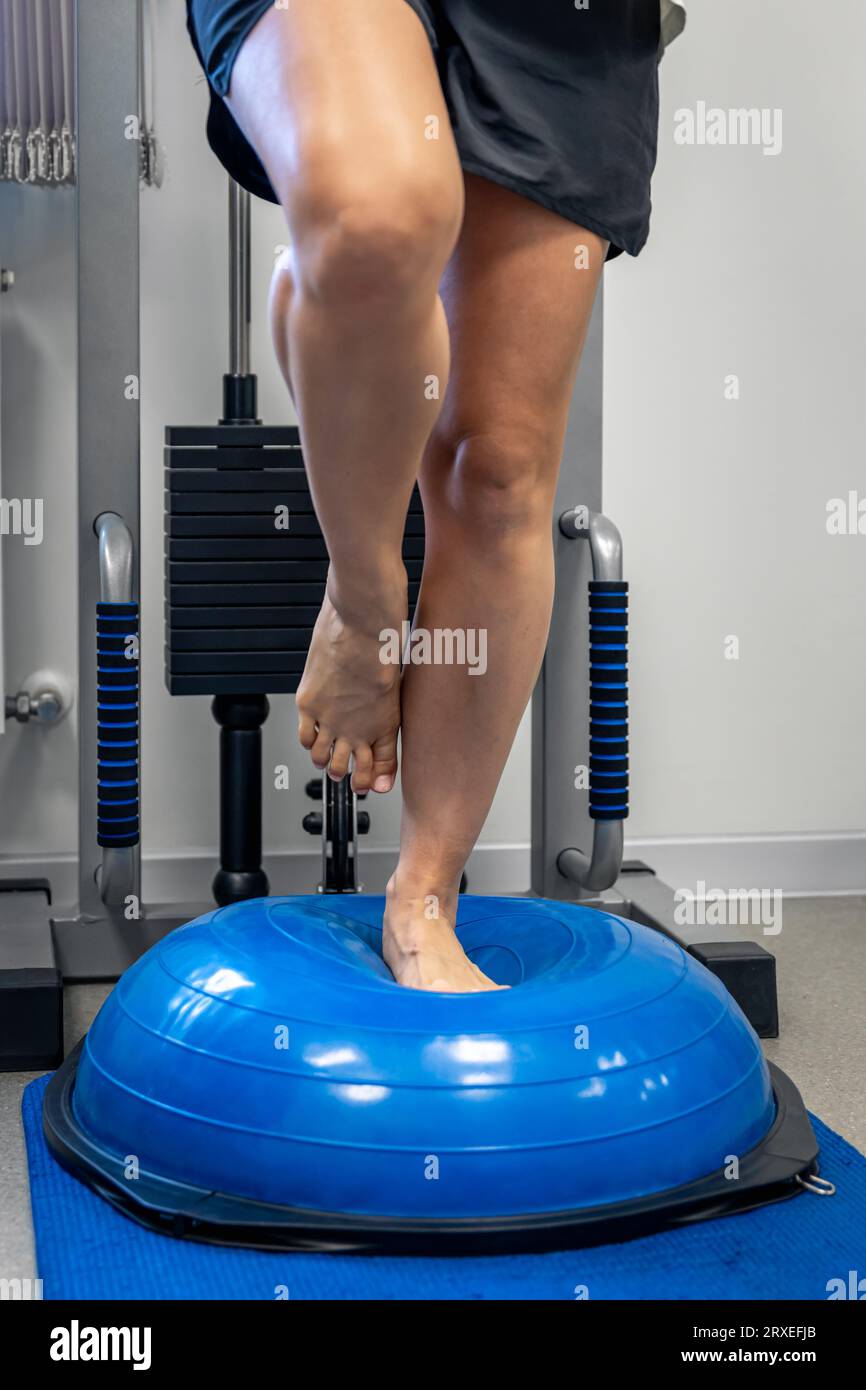 Balance exercise with bosu ball, woman and in a gym Stock Photo - Alamy