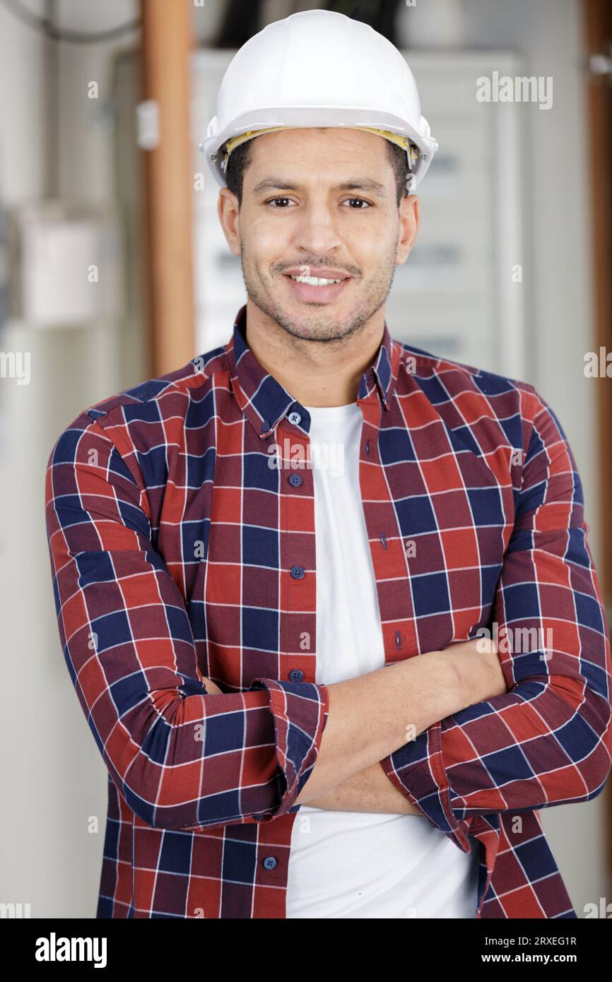 young engineer worker wears yellow helmet with arm crossed Stock Photo ...