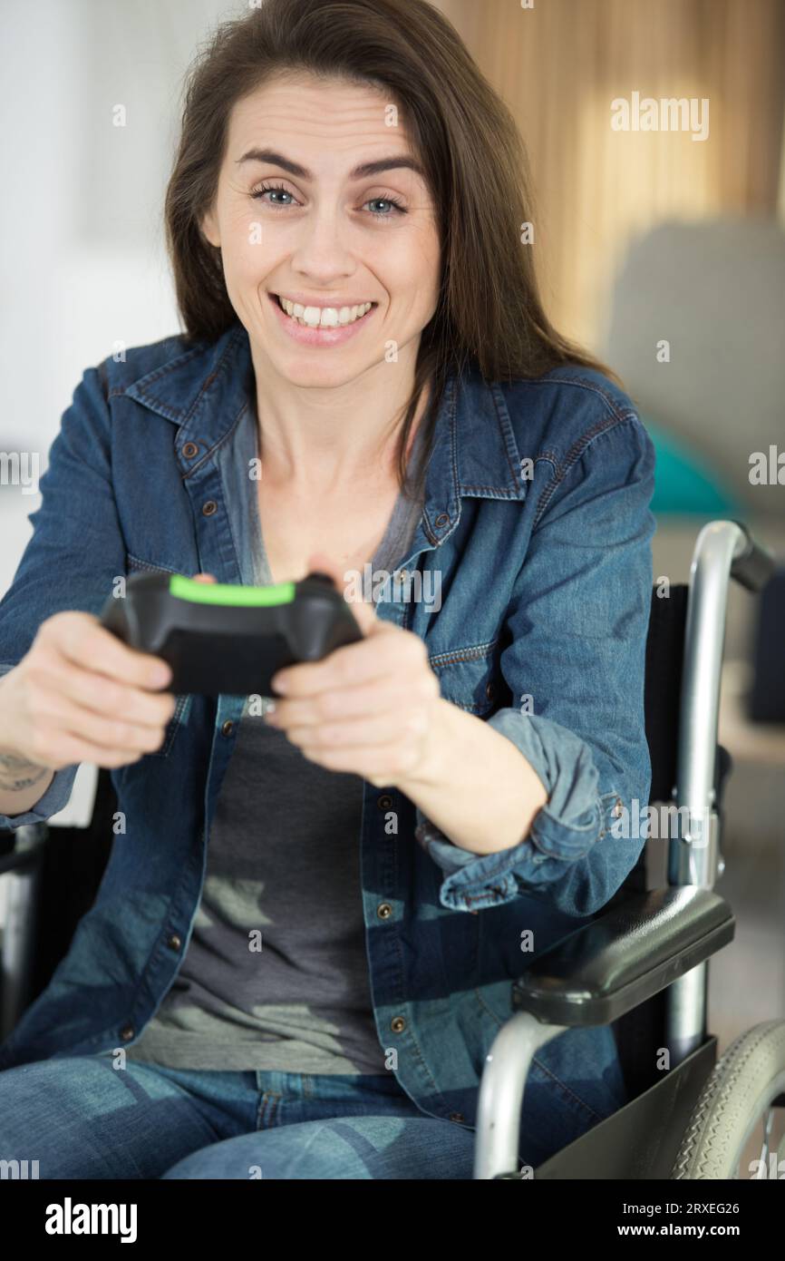 Playing computer game in wheelchair hi-res stock photography and images ...