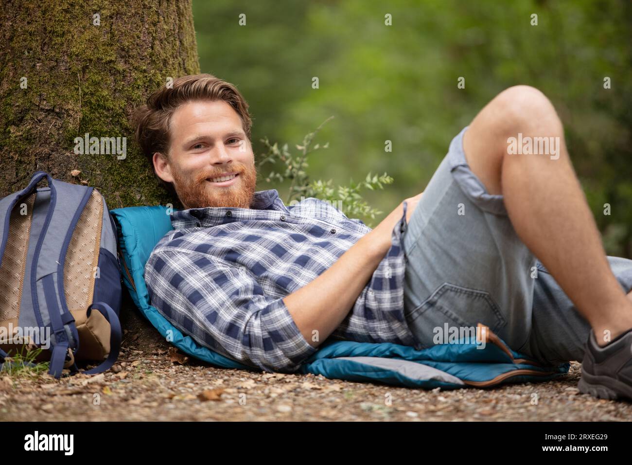 Man sitting under tree hi-res stock photography and images - Alamy