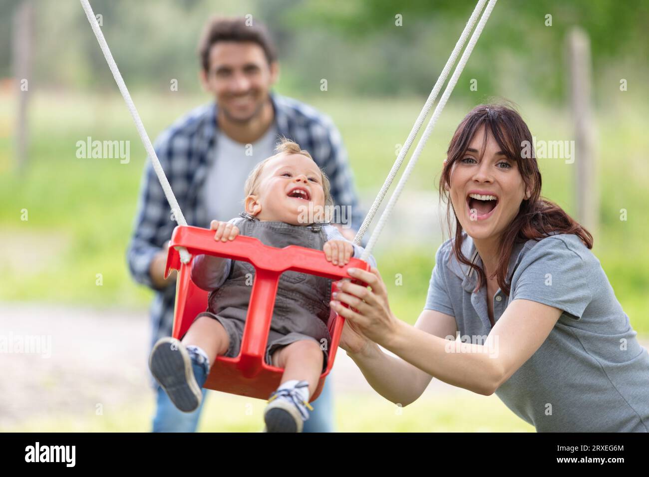 parents playing with their child Stock Photo - Alamy