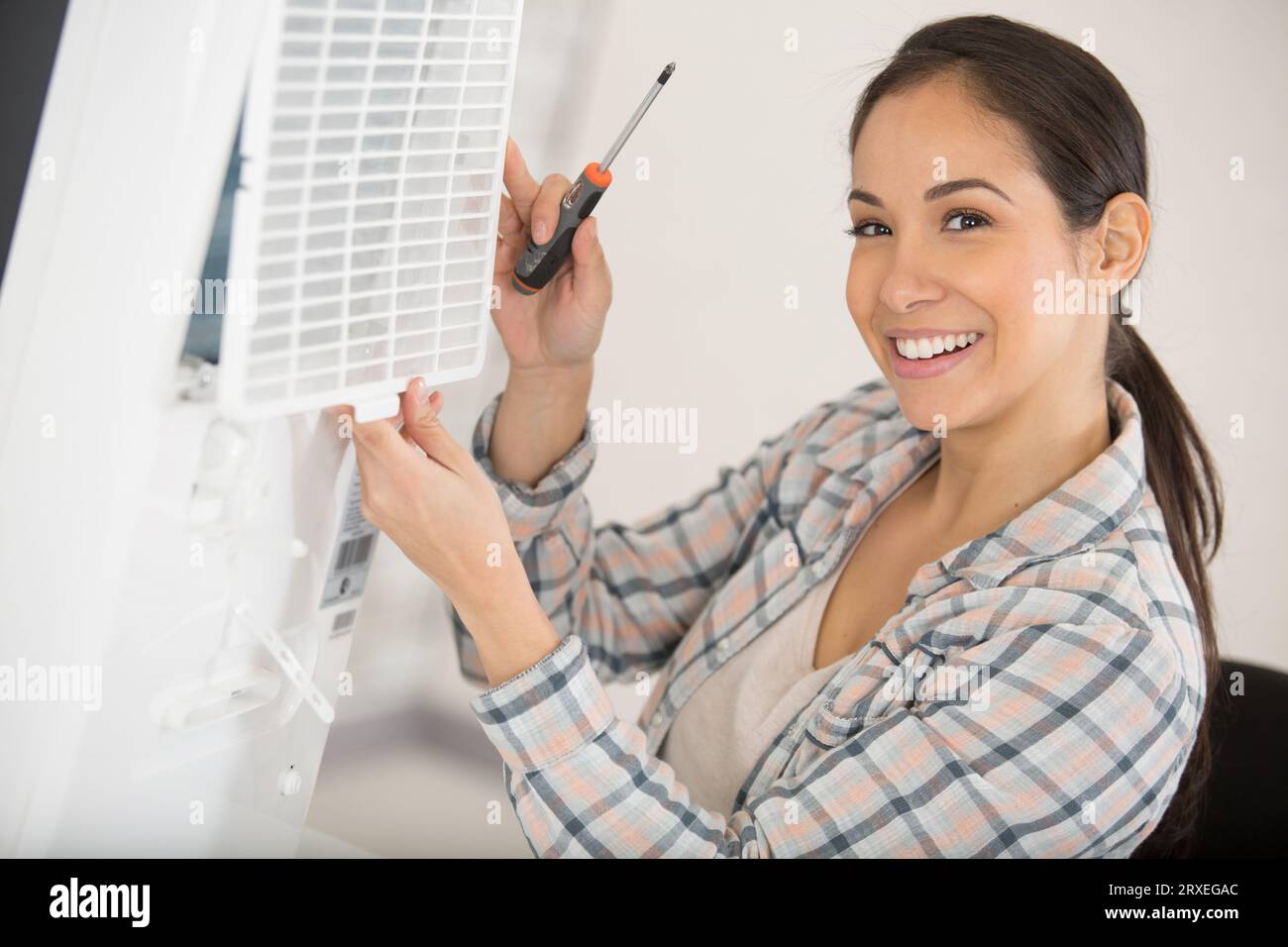 female worker repairing air conditioner Stock Photo - Alamy
