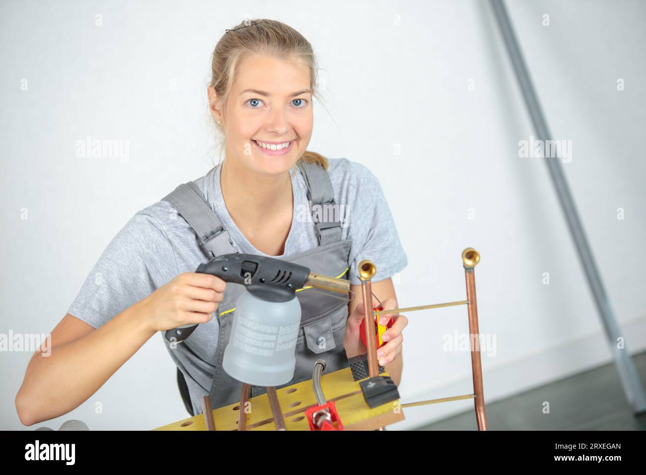 woman using a blowtorch on copper pipes Stock Photo - Alamy