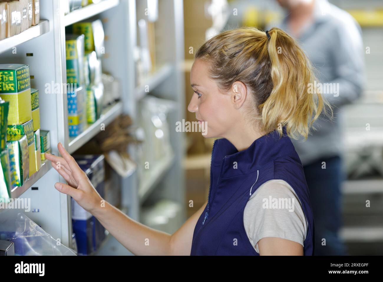 worker looking shelves in a warehouse Stock Photo - Alamy