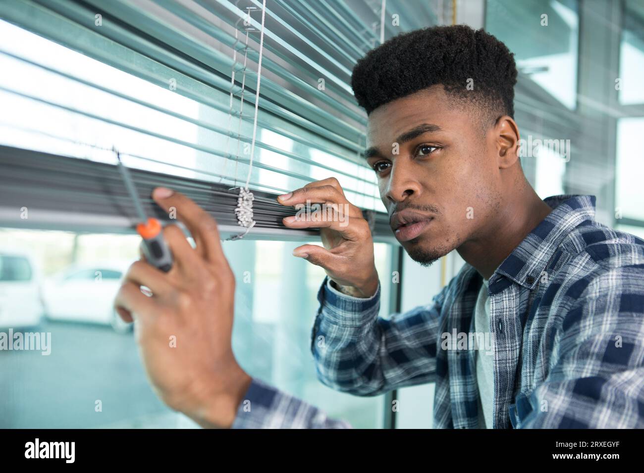 young man installing window blinds at home Stock Photo - Alamy
