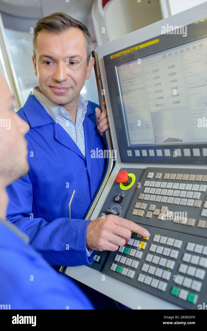 Male factory workers operating machinery hi-res stock photography and ...