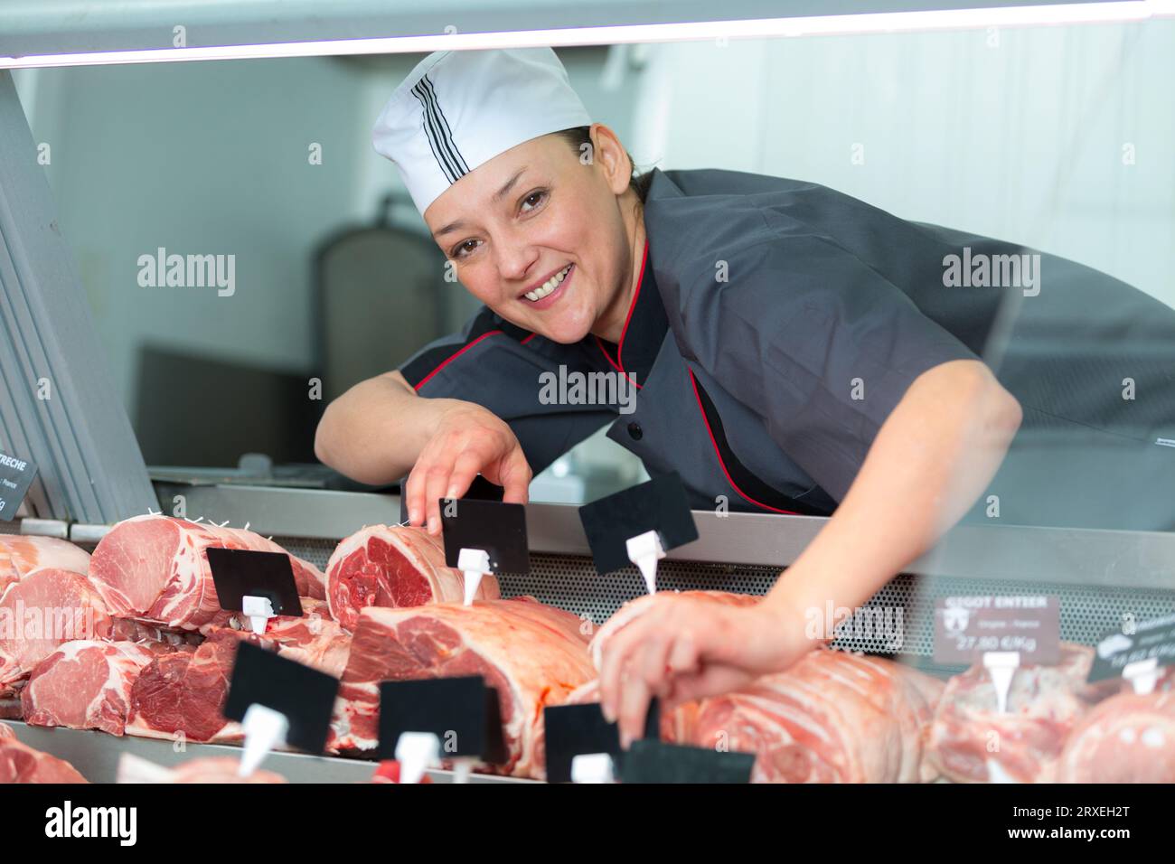 female butcher posing and smiling Stock Photo - Alamy