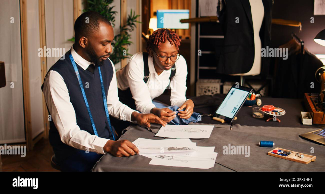 African american tailors picking fabric to create luxury fashion collection with tailoring tools ...