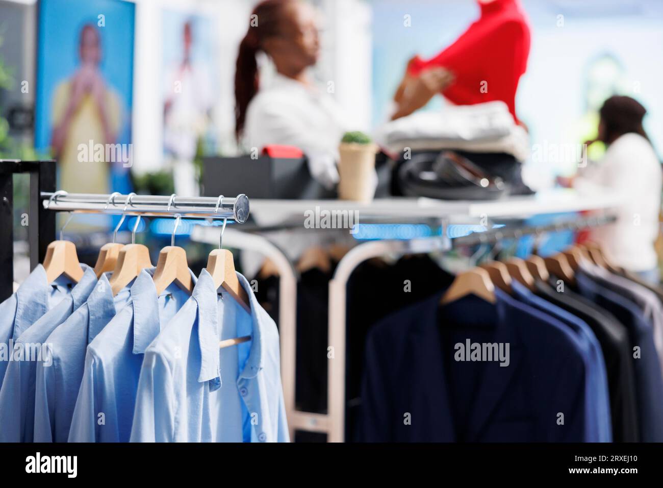 Formal shirts and jackets hanging on display rack showcasing latest ...