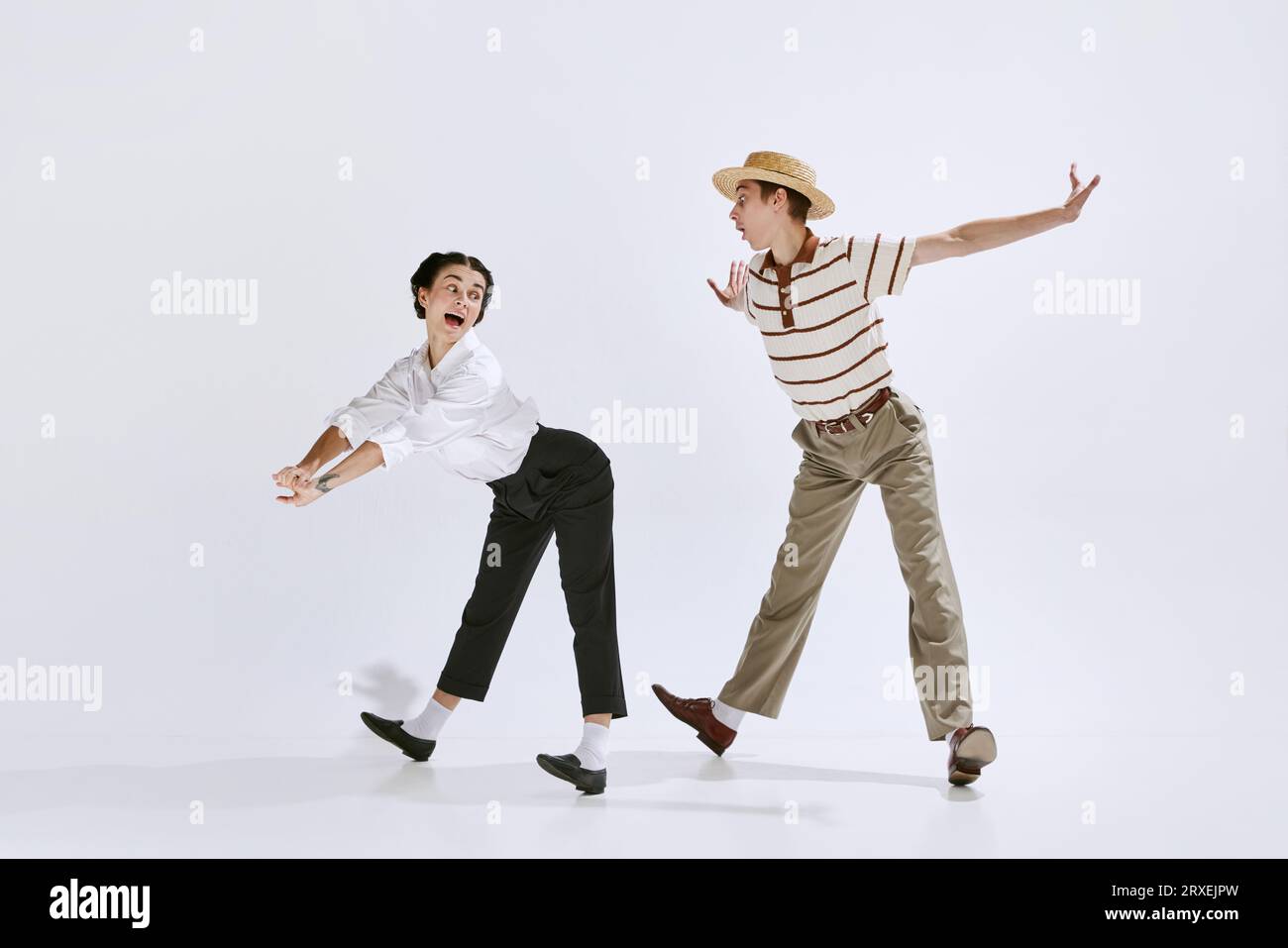 Beautiful young woman and man in stylish retro clothes dancing lindy ...