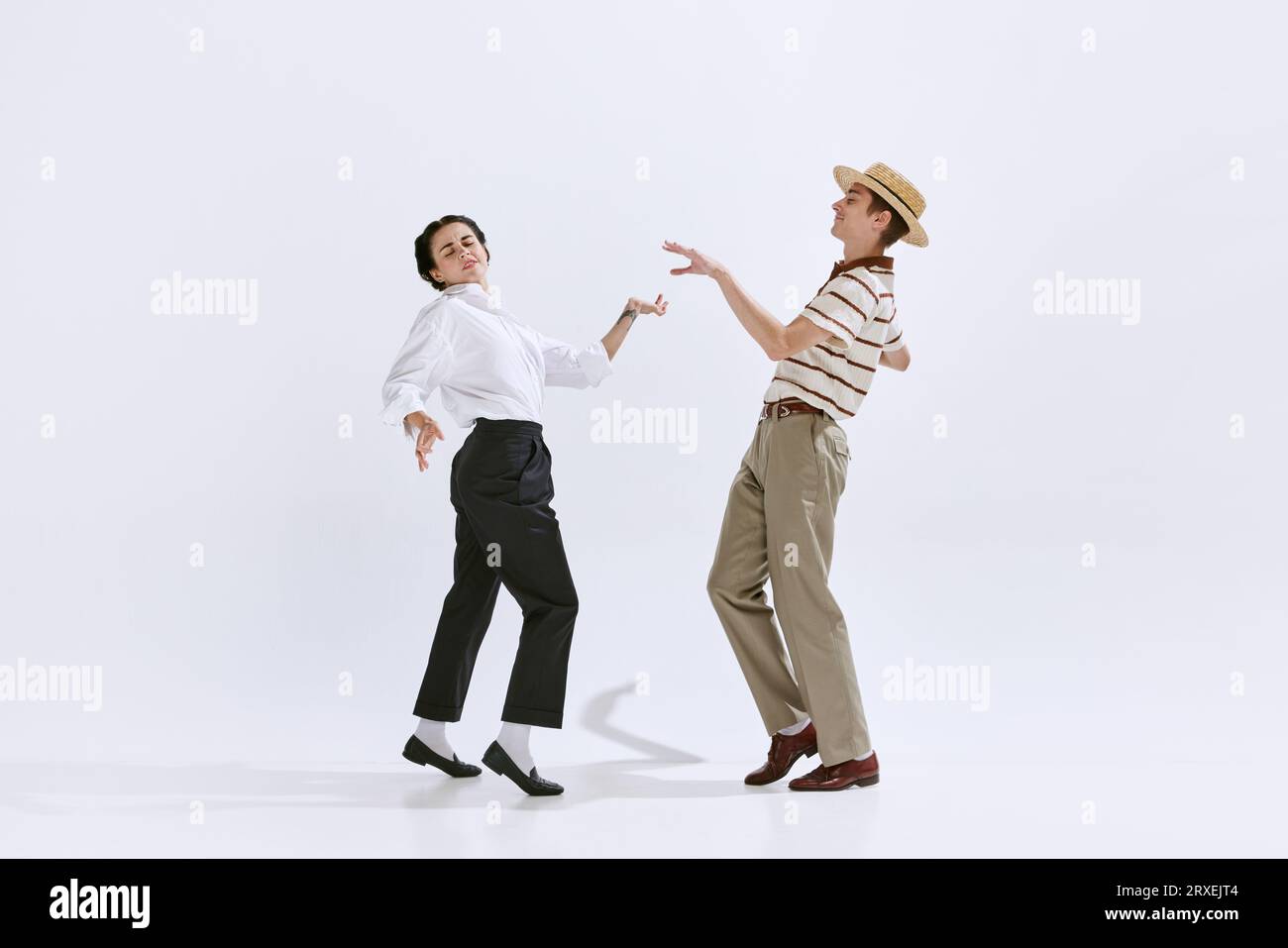 Beautiful young woman and man in stylish retro clothes dancing lindy ...