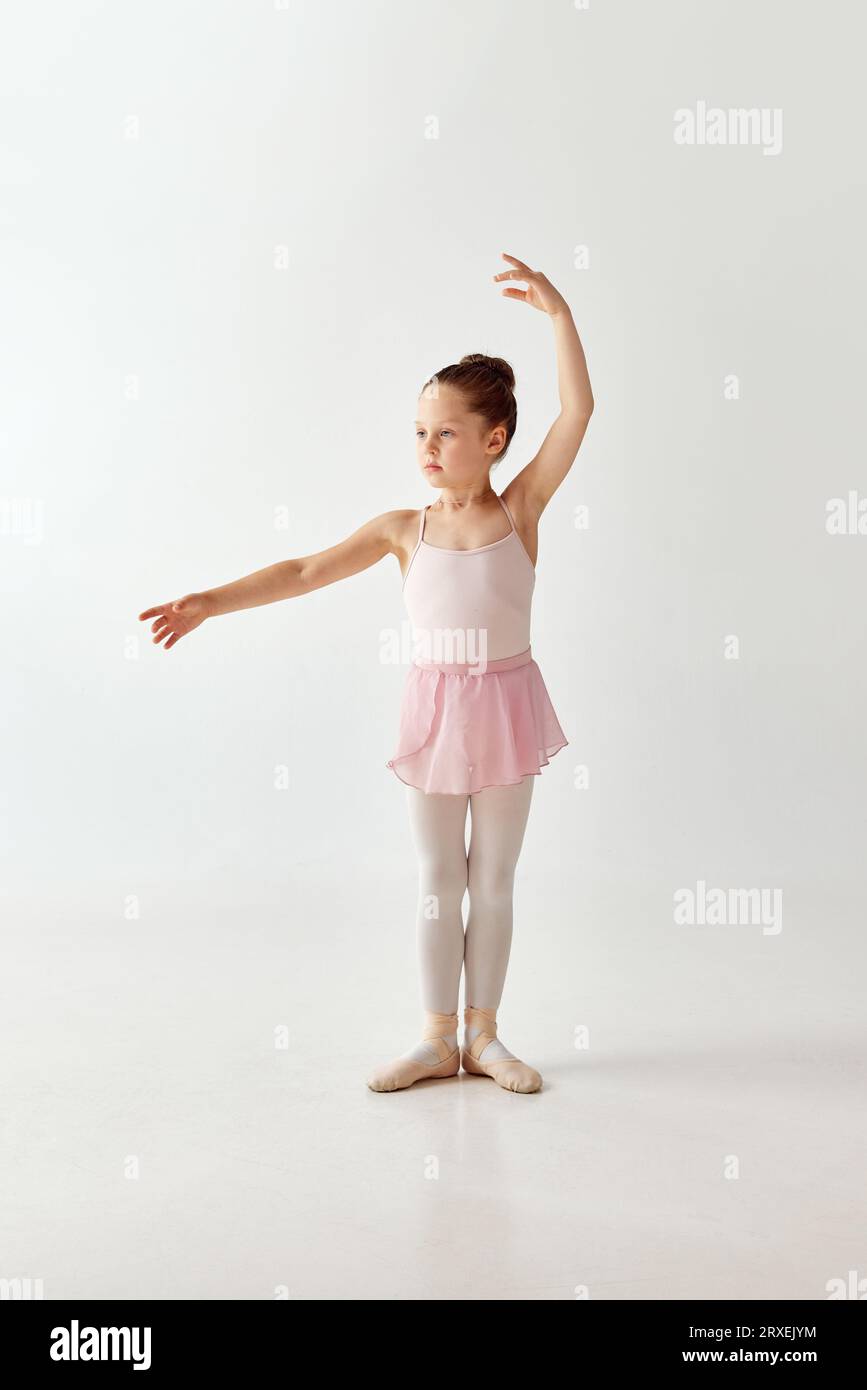 Portrait of small adorable preschool ballerina dancer girl in rose tutu ...