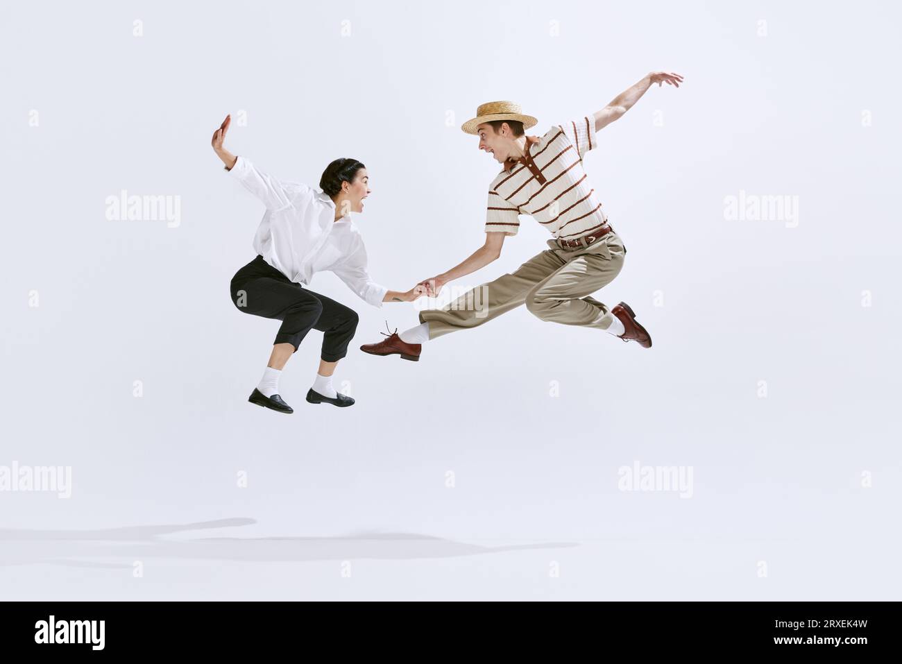 Happy, attractive young man and woman in stylish vintage clothes ...