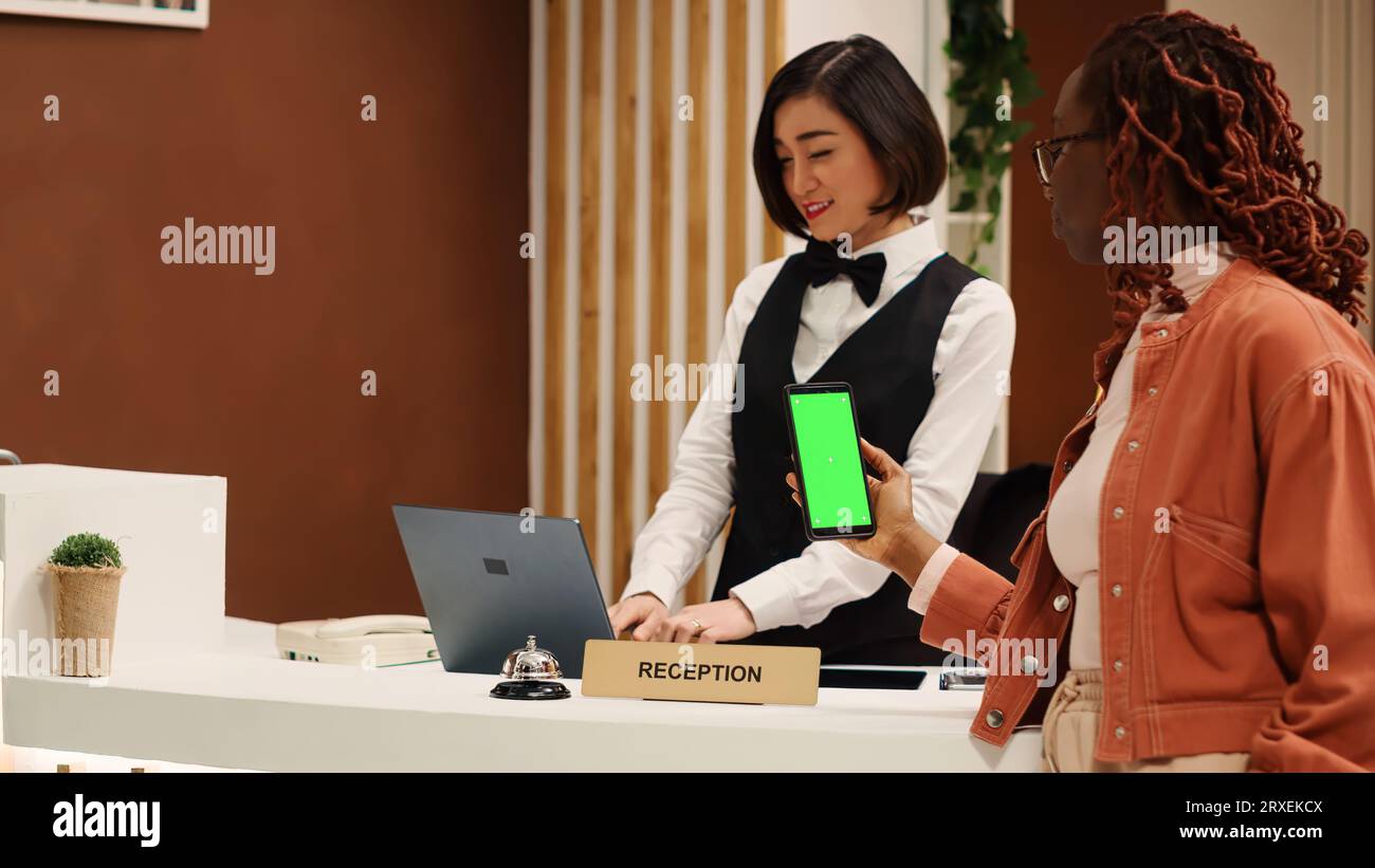 Tourist holding chroma key green screen mock up smartphone waiting at ...