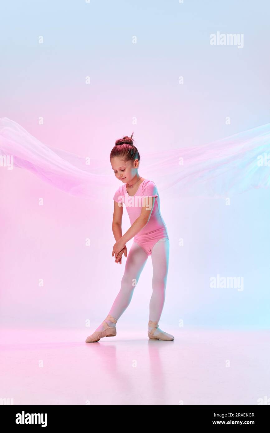 Portrait of small cute ballerina dancer girl wearing ballet swimsuit ...