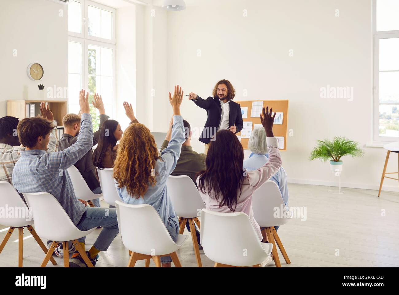 People colleagues raising hands to ask questions during business ...