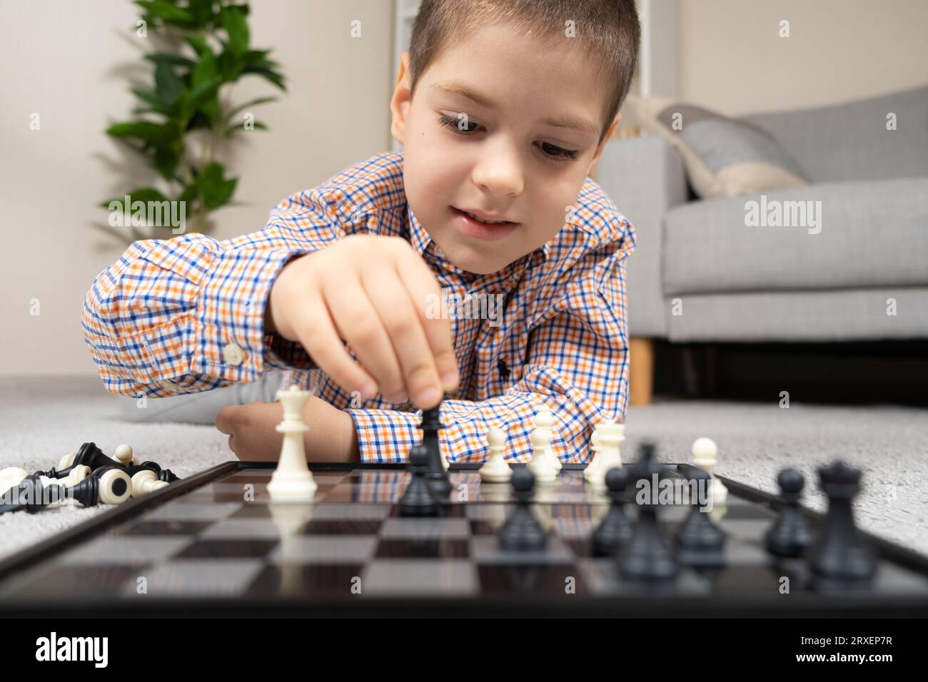 Little boy playing chess. Board games for children Stock Photo - Alamy