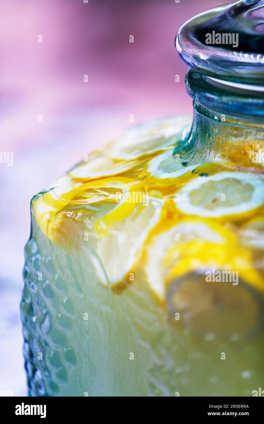 Close up, cropped view of sliced lemons in a glass container of ...
