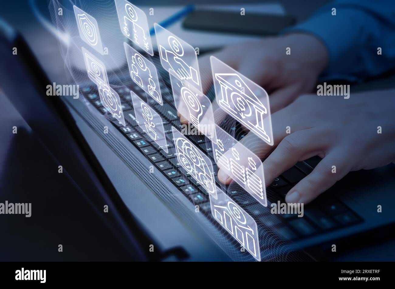 Close-up of a man's hands on a laptop keyboard and virtual screen with ...