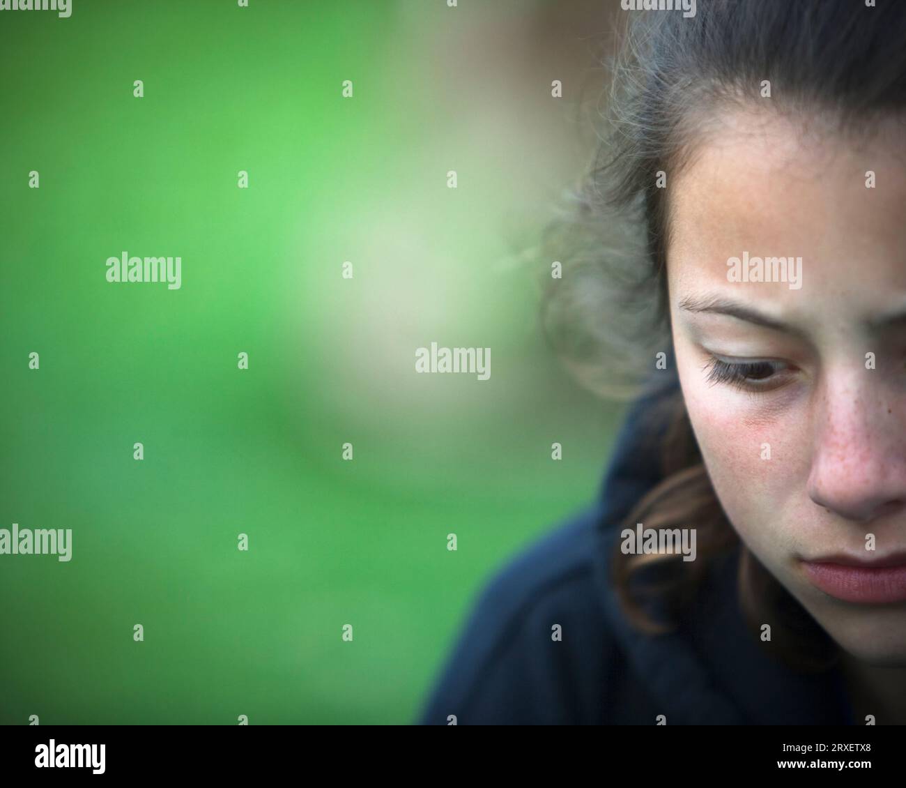 Portrait of a young girl looking sad Stock Photo - Alamy