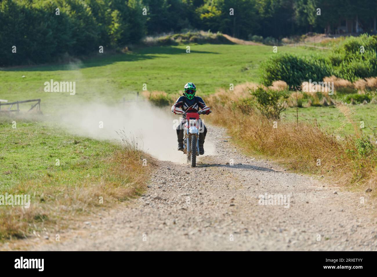 A professional motocross rider exhilaratingly riding a treacherous off ...