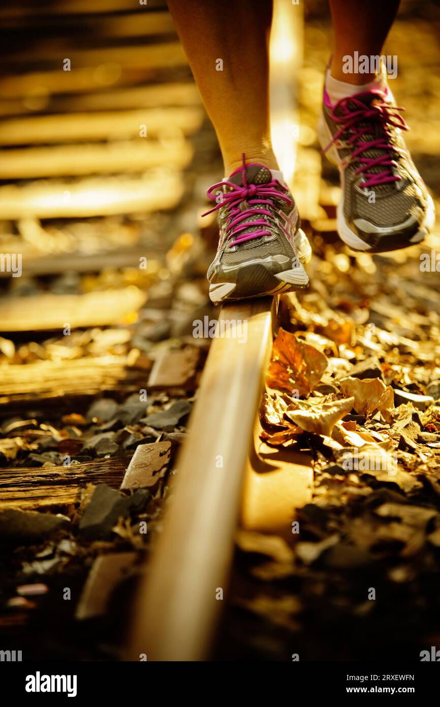 Front view of a woman's legs walking on a railroad track Stock Photo ...