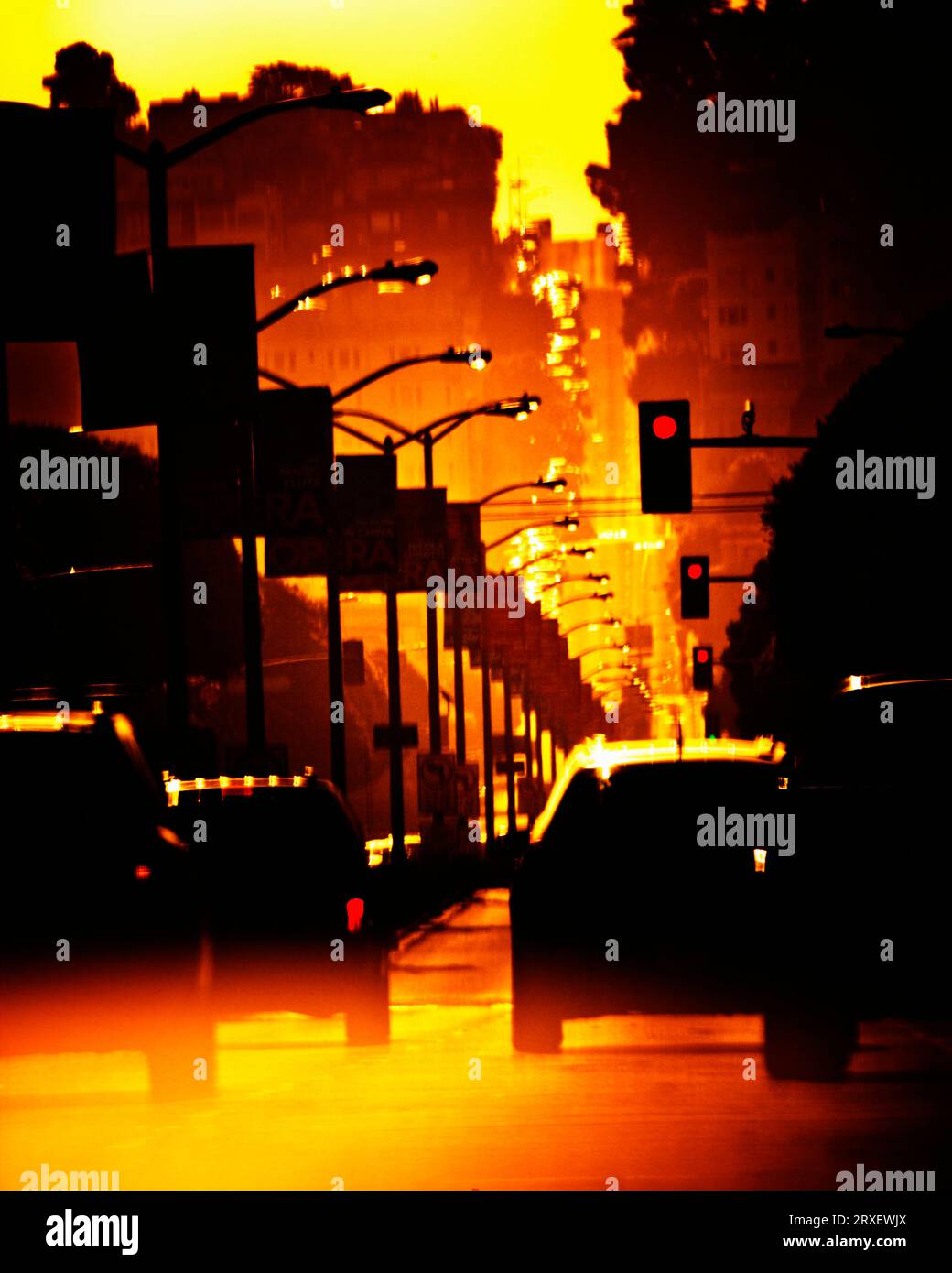 Automobiles, street lights and traffic signals in a city street Stock ...