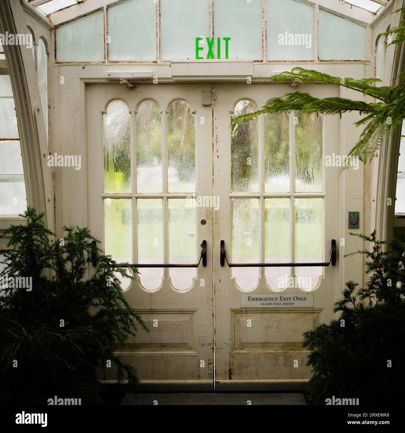 White glass paned double exit doors Stock Photo - Alamy