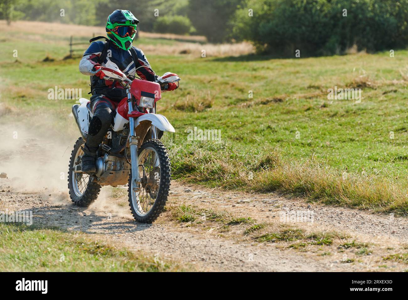 A professional motocross rider exhilaratingly riding a treacherous off ...