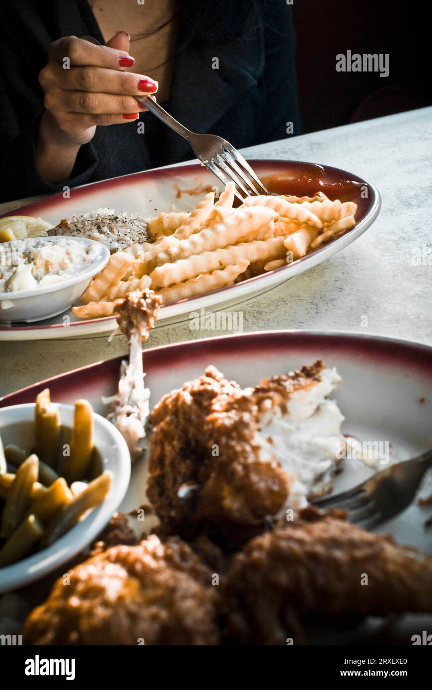 Couple of plates of food on the table of a diner Stock Photo - Alamy