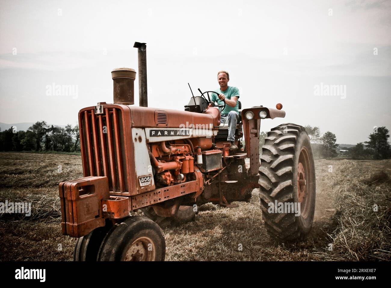 A man drives his tractor through a field at his family's dairy farm in ...