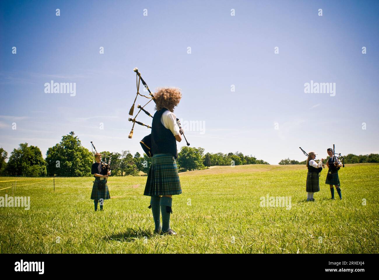 A group of four high school Celtic band members warm up during the ...