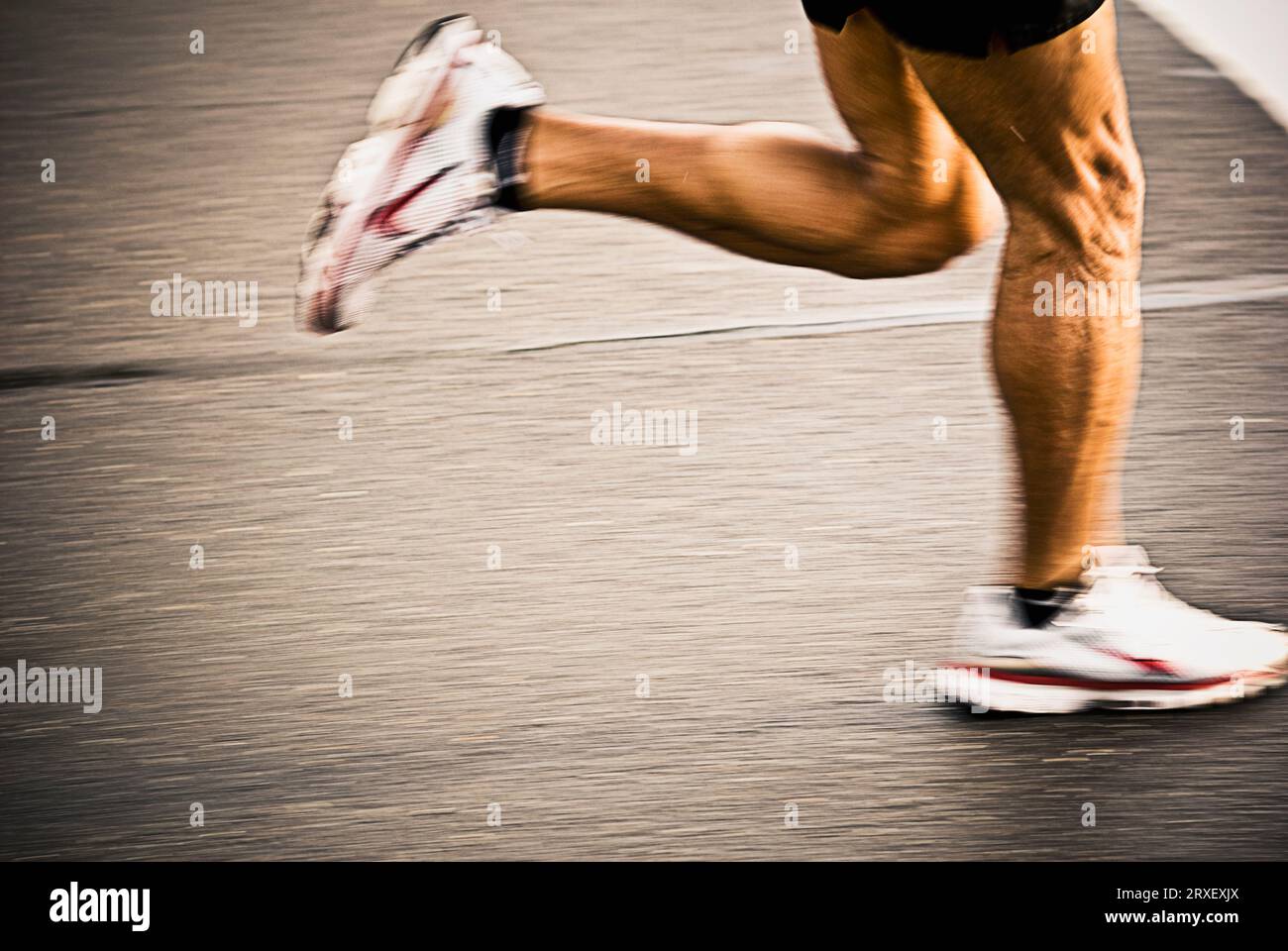Close up of blurred feet and legs of 10k road race runner. Herndon, VA ...