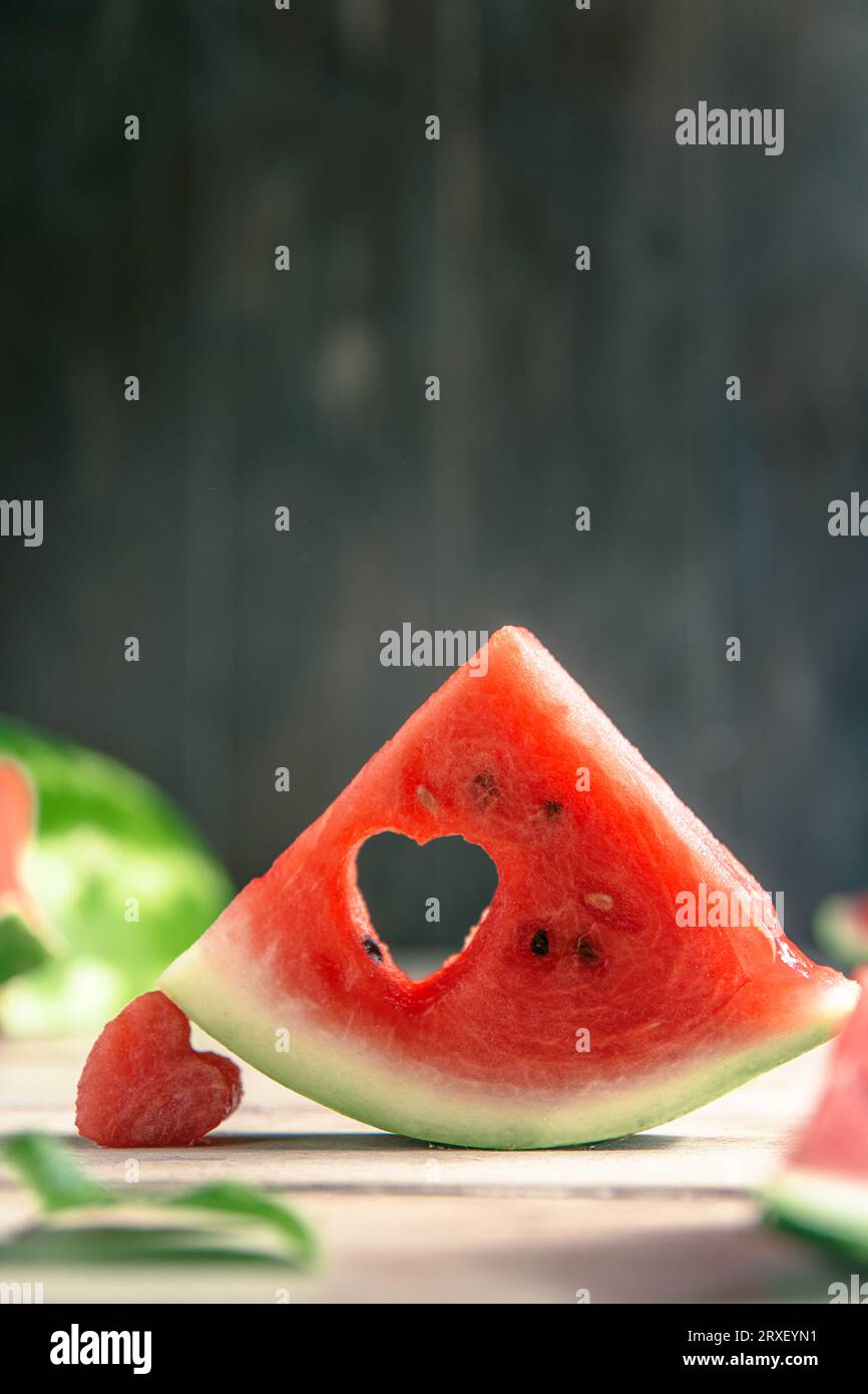 A cut piece of watermelon with a heart-shaped hole. concept Summer, joy ...