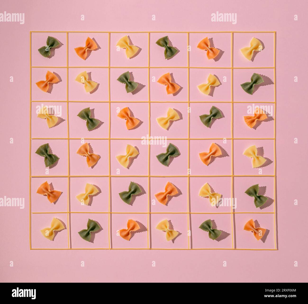 Creative pattern made of colorful pasta on pastel pink background ...