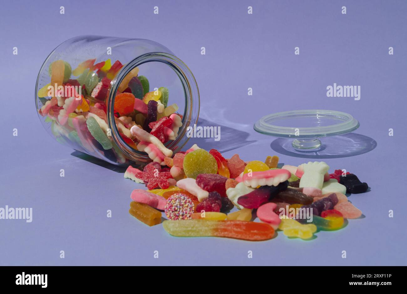Creative layout made of colorful gummy candies on pastel violet ...