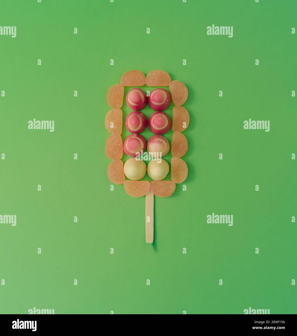 Ice cream made with gummy candies on pastel green background. Minimal ...