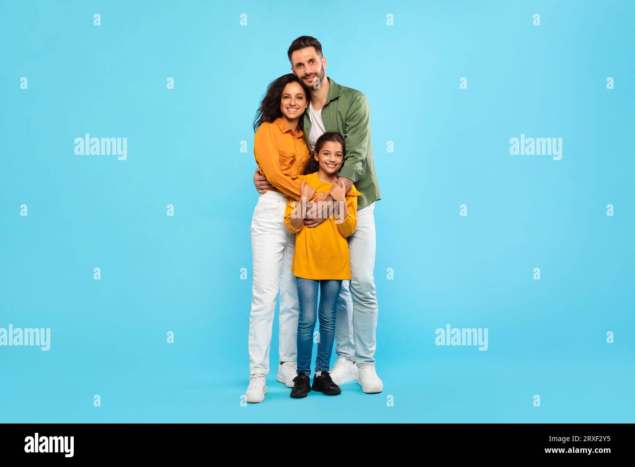 Healthy family relationship. European dad and mom embracing daughter ...