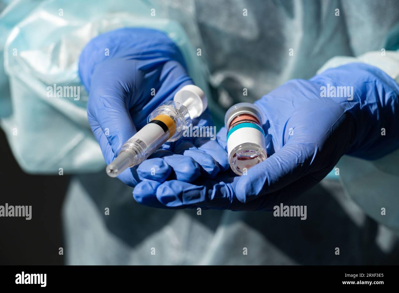 Doctor holds syringe and injection medicine Stock Photo - Alamy